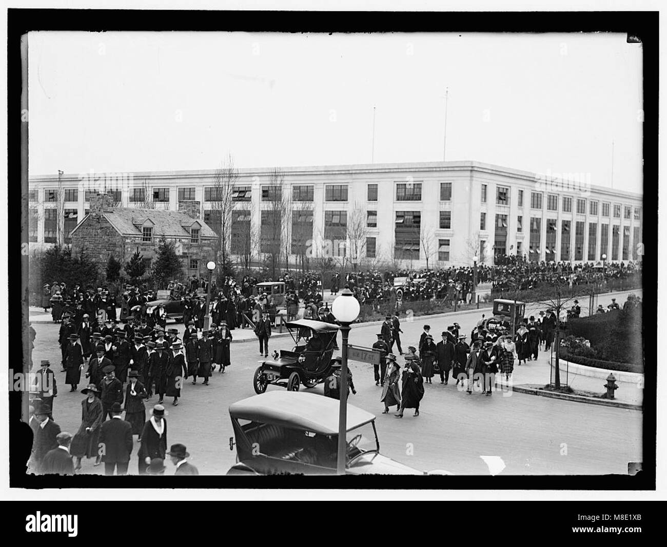 This historical image depicts U.S. workers leaving the Navy Department ...