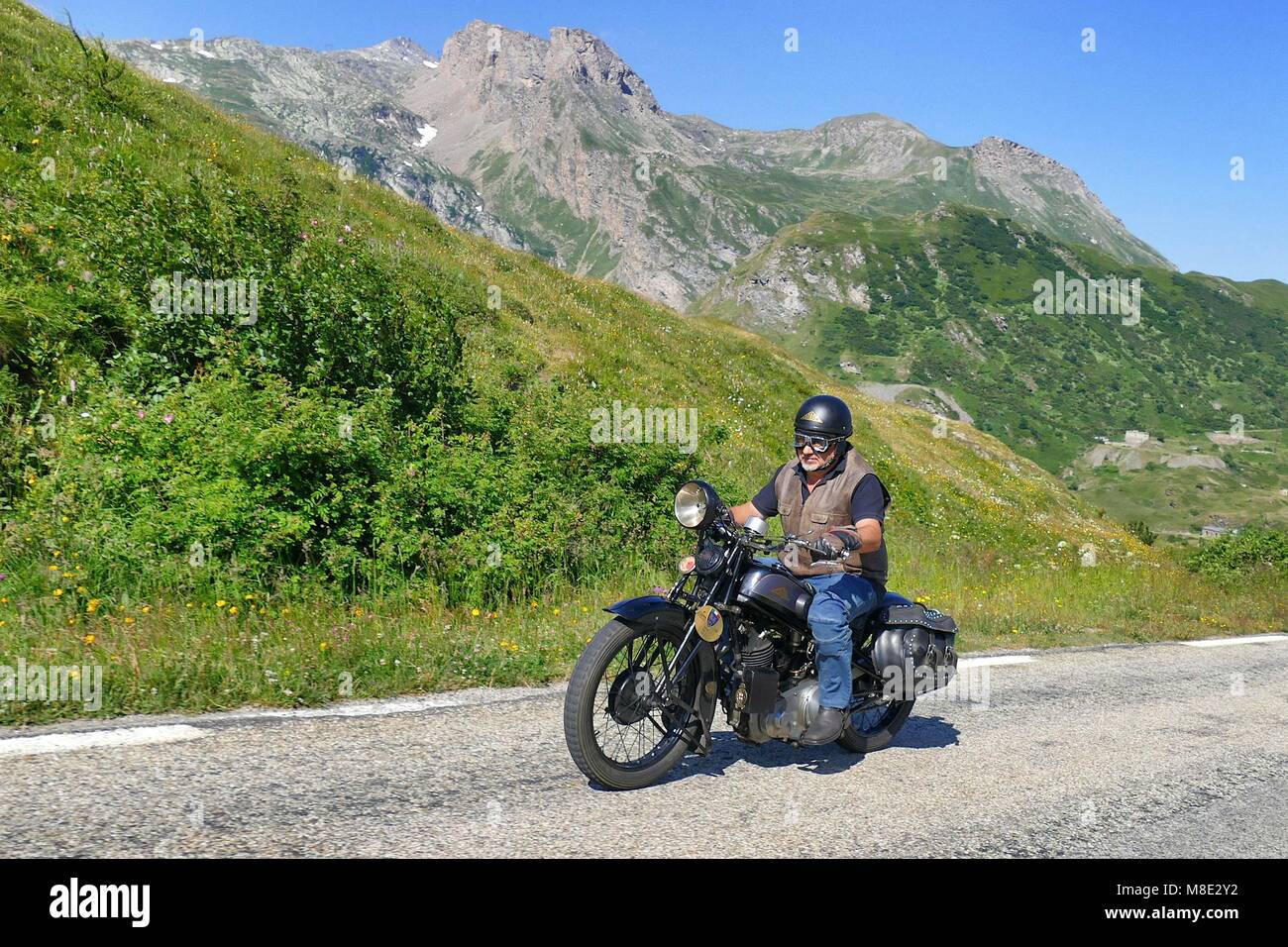 Single vintage motorbike rider front view on the ride in mountain ...