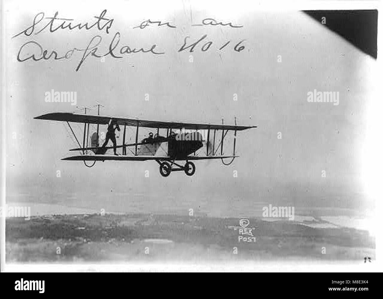 A photograph of stunts being performed on an airplane, capturing the ...