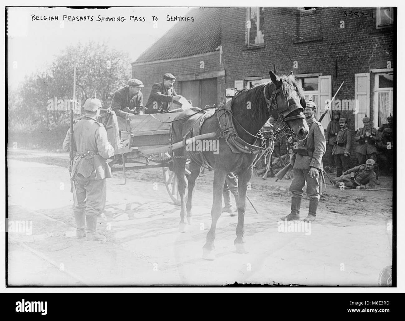 Belgian peasants during wartime, showing passes to sentries at a ...