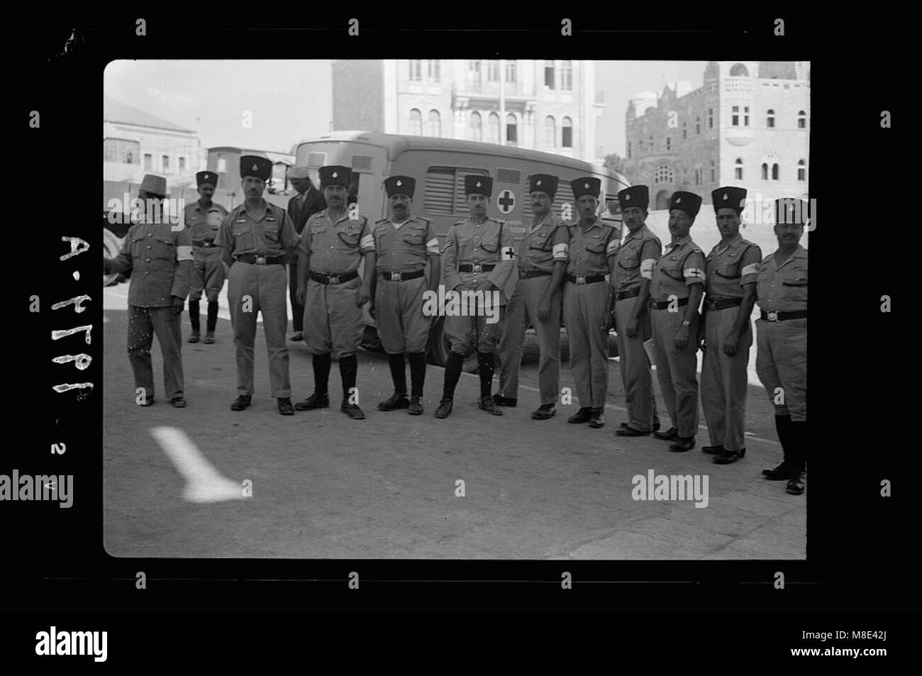 This image captures a squad of Red Cross men from the Health Department ...