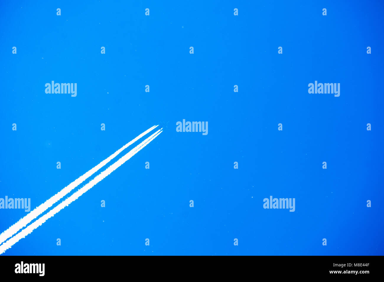 Plane and trace in the sky Stock Photo - Alamy