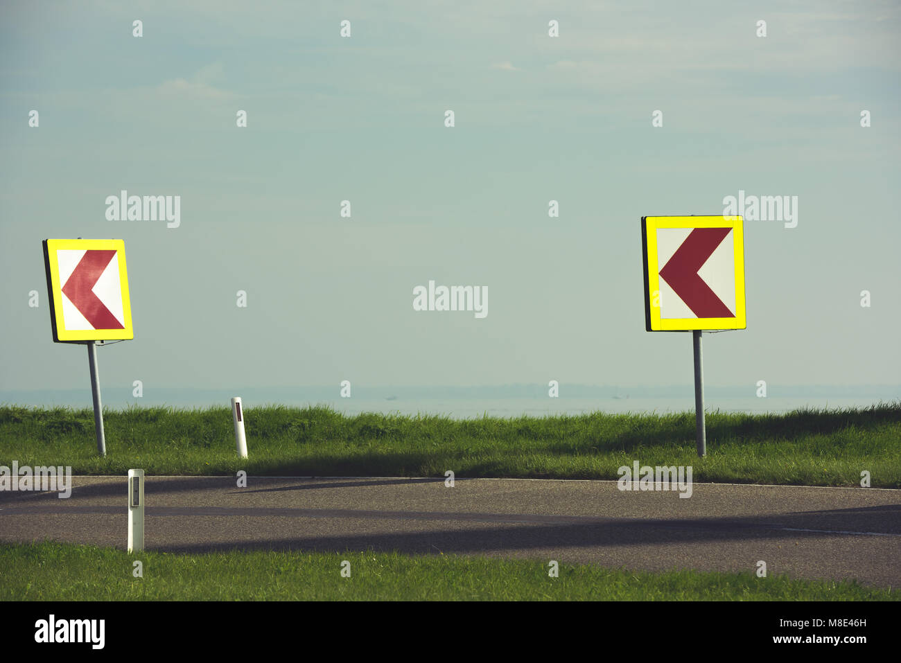 Road signs warning drivers about ahead dangerous curve Stock Photo - Alamy