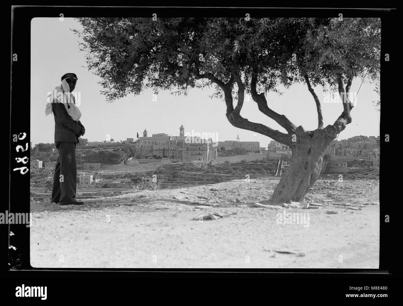 A distant view of the Church of the Nativity in Bethlehem, framed by an ...