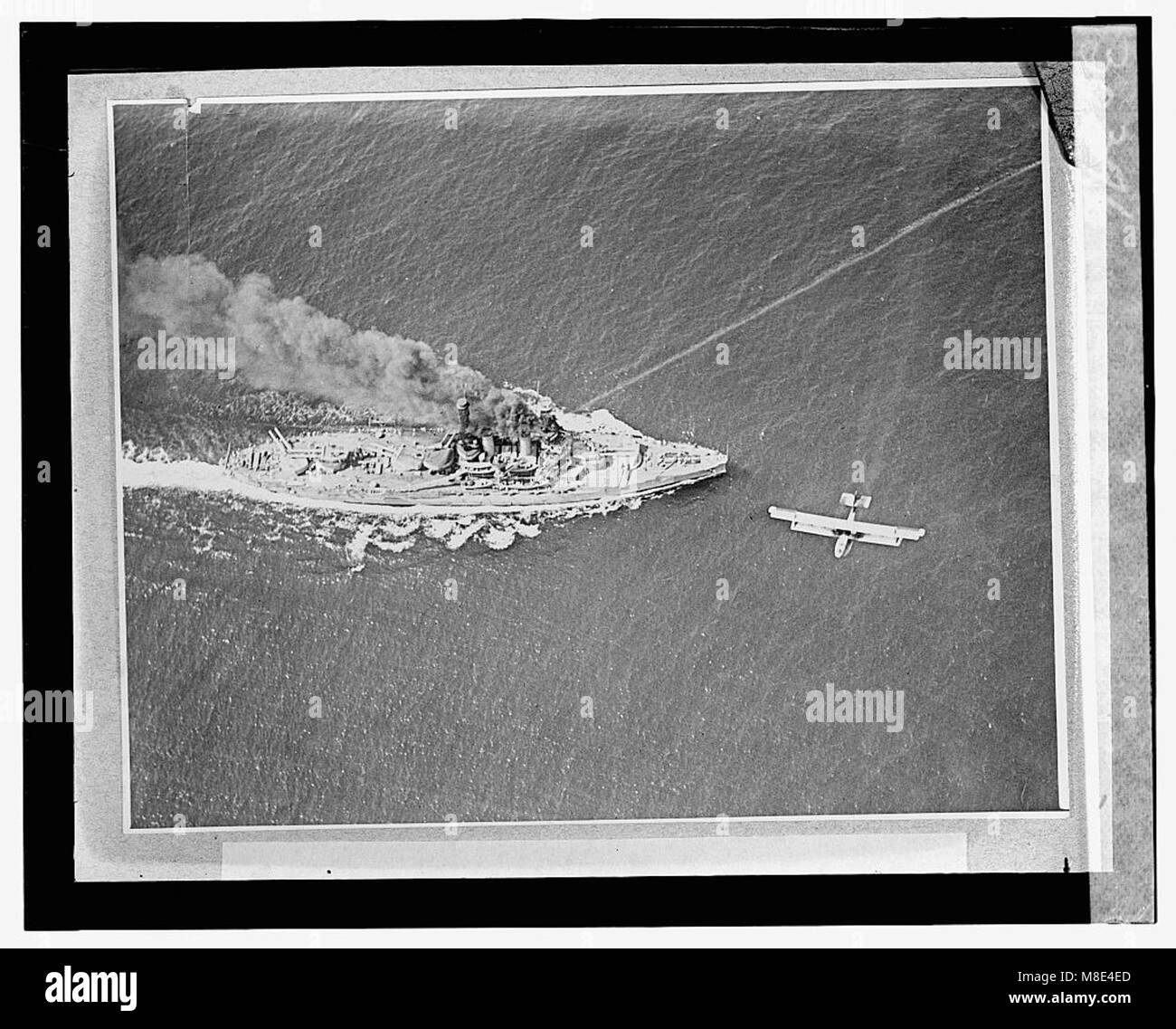 This photograph captures the wake of a torpedo striking the USS ...