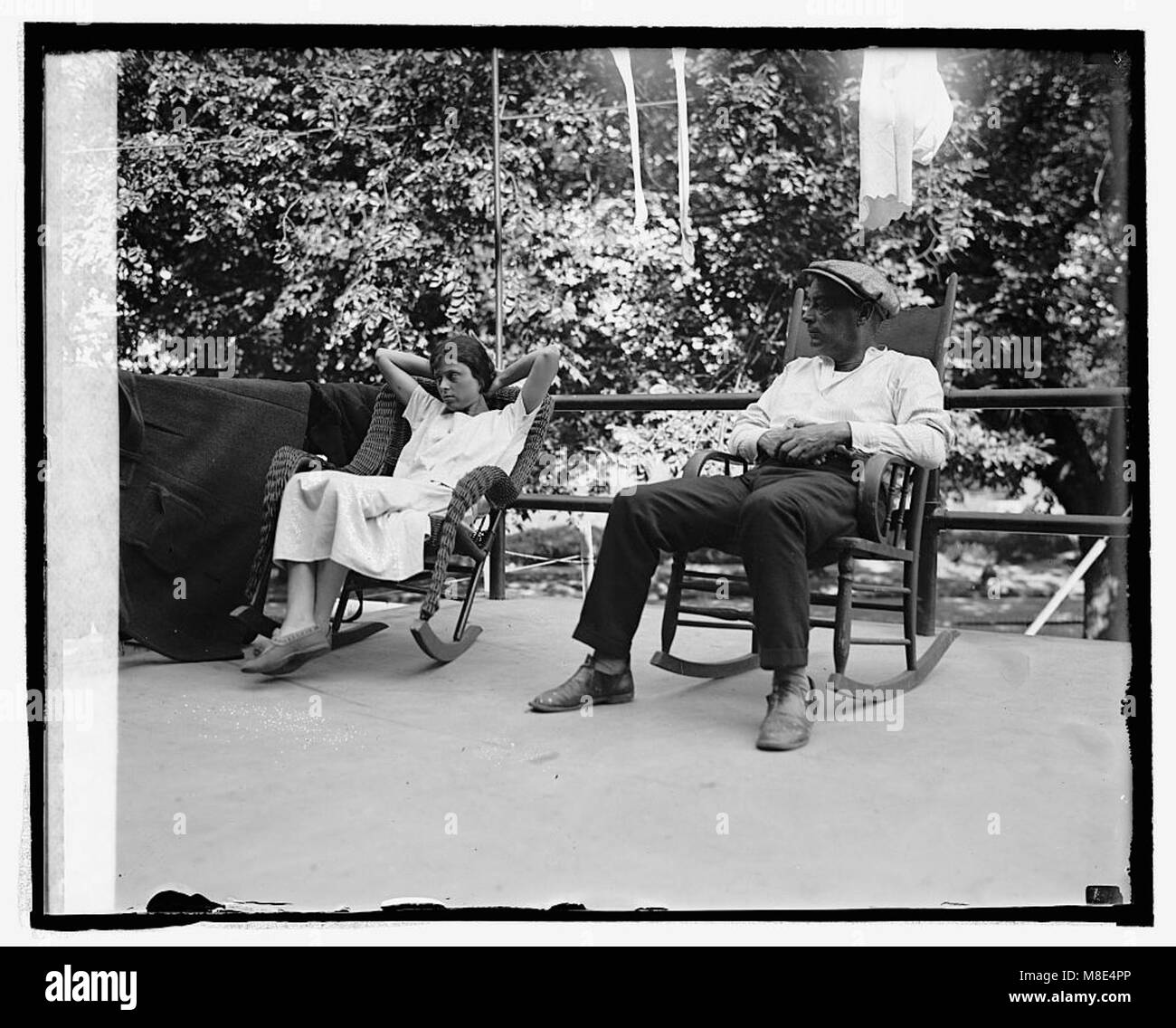 Woman and man seated in rocking chairs LOC npcc.12132 Stock Photo - Alamy