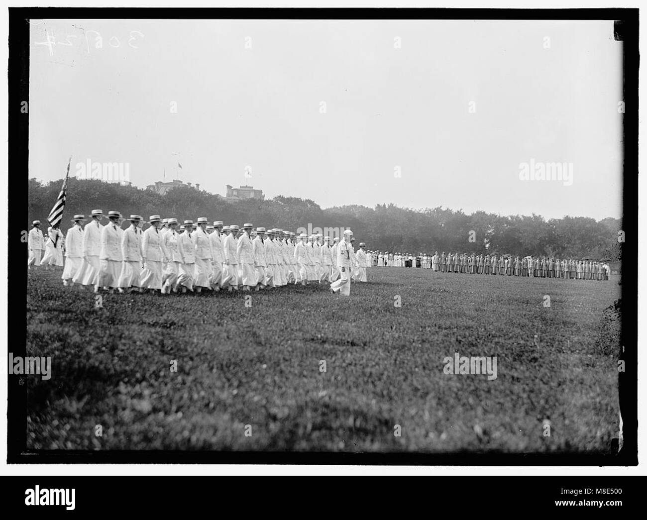 A photograph of a yeoman from the Navy Department being reviewed by ...