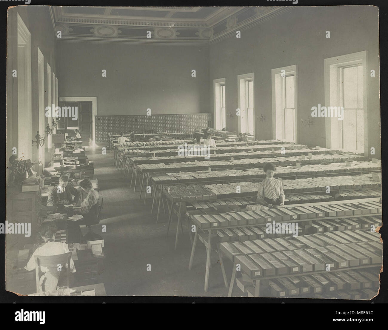 This photograph shows Library of Congress staff working at desks and ...
