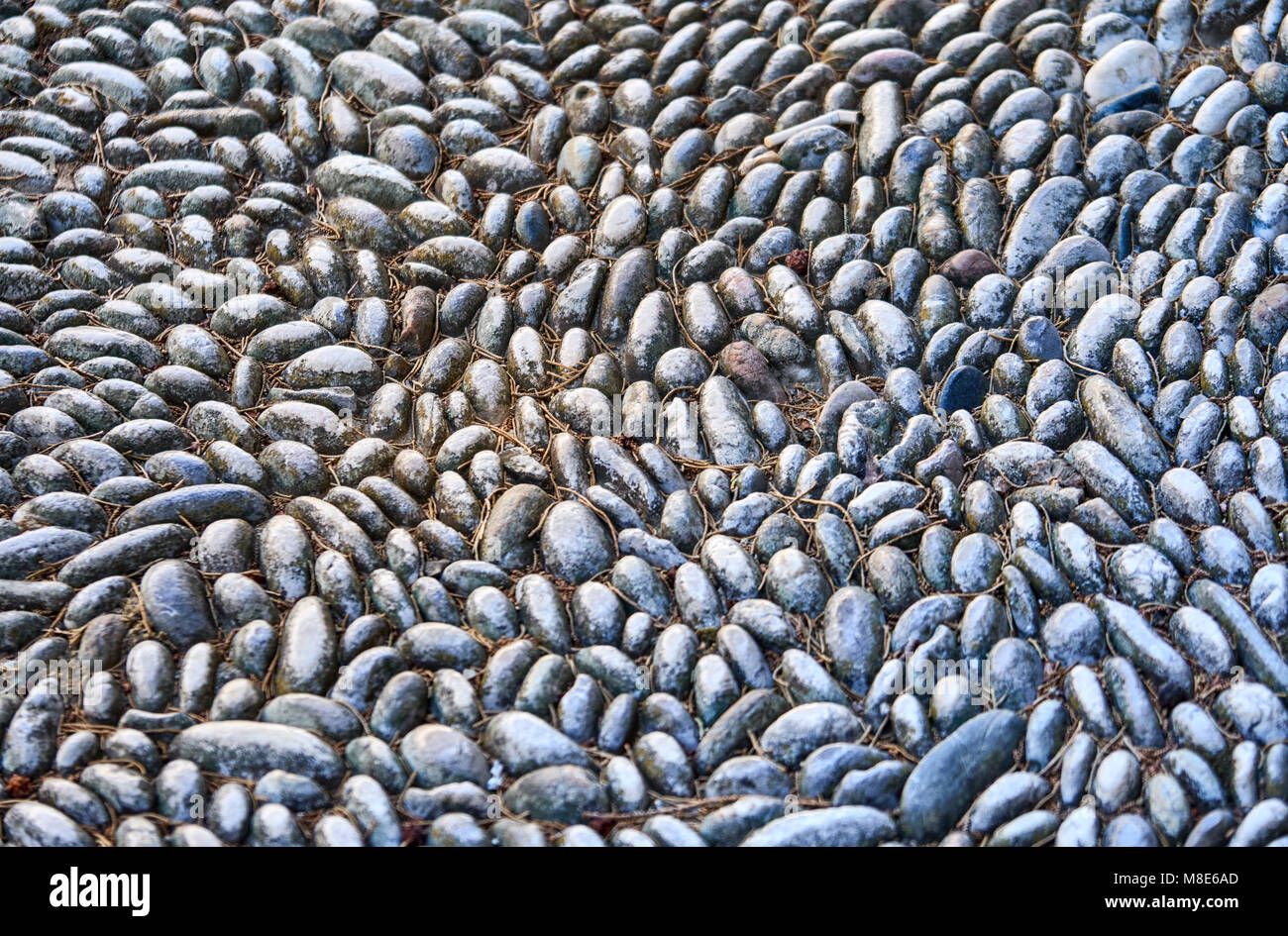 Stylish road pattern made with small shiny pebbles for park and garden ...