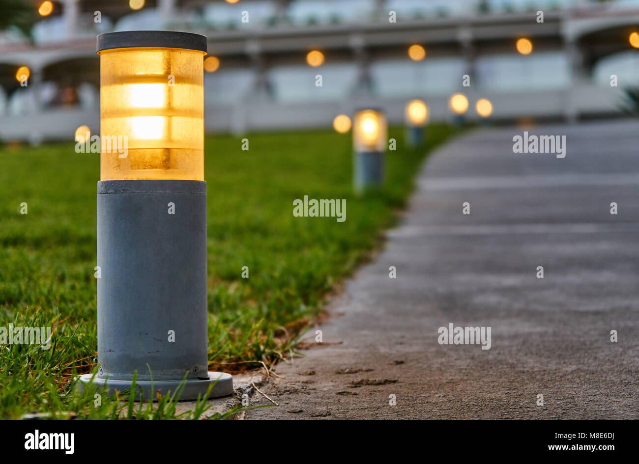 Street lights located along the footpath on the grass in hotel ...