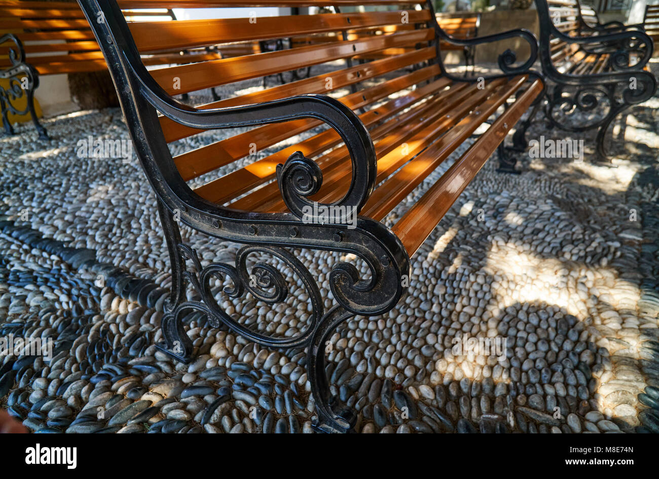 Benches standing on a pebble in a shady place Stock Photo - Alamy