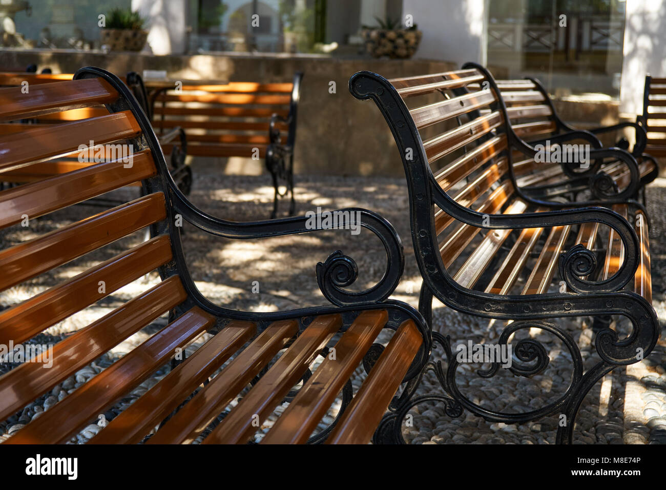 Benches standing on a pebble in a shady place Stock Photo - Alamy