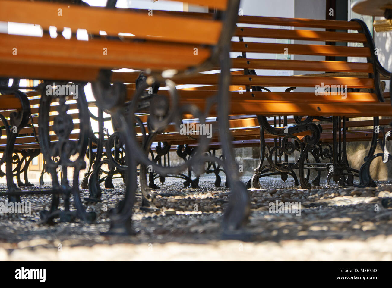 Benches standing on a pebble in a shady place Stock Photo - Alamy