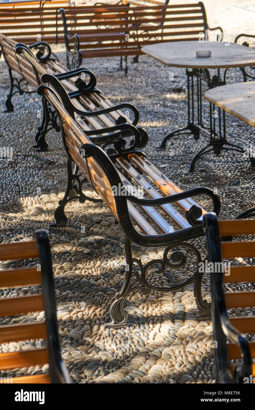 Benches standing on a pebble in a shady place Stock Photo - Alamy