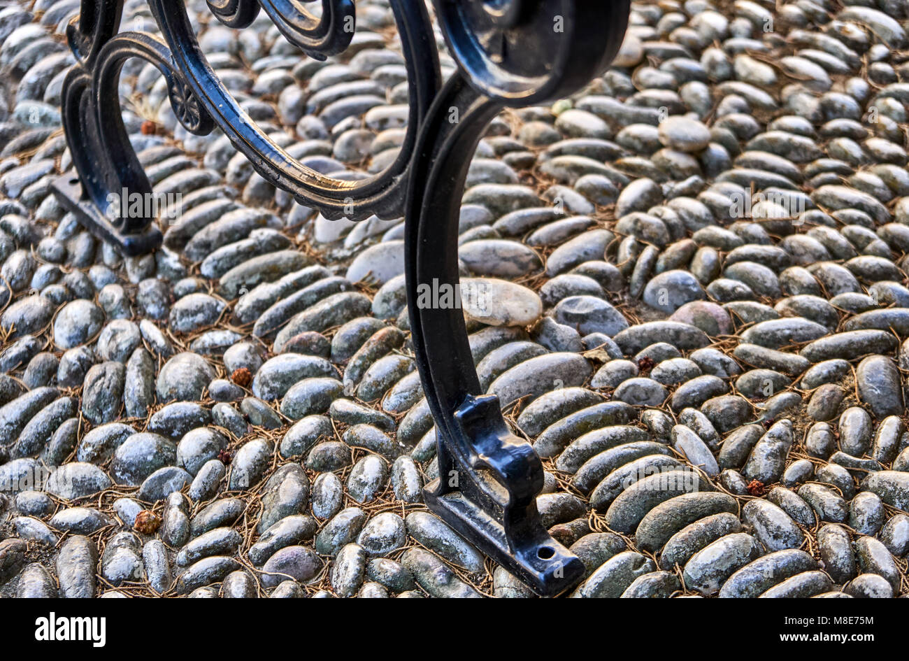 Benches standing on a pebble in a shady place Stock Photo - Alamy