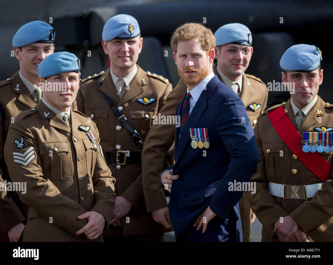Prince Harry (centre right) poses for a photograph in front of an ...
