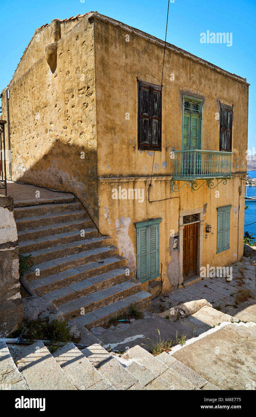 Old yellow building with green shutters by the sea Stock Photo - Alamy
