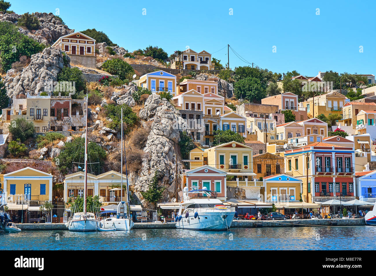 Multi-colored houses on the rocky coast of Simi Island Stock Photo - Alamy