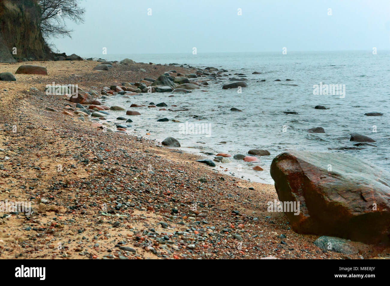 small stones on the coast, low waves run into the sea coast, Sea waves ...
