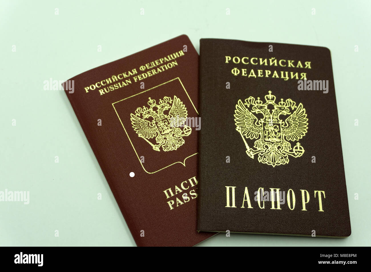 Two red passports, white background Stock Photo - Alamy