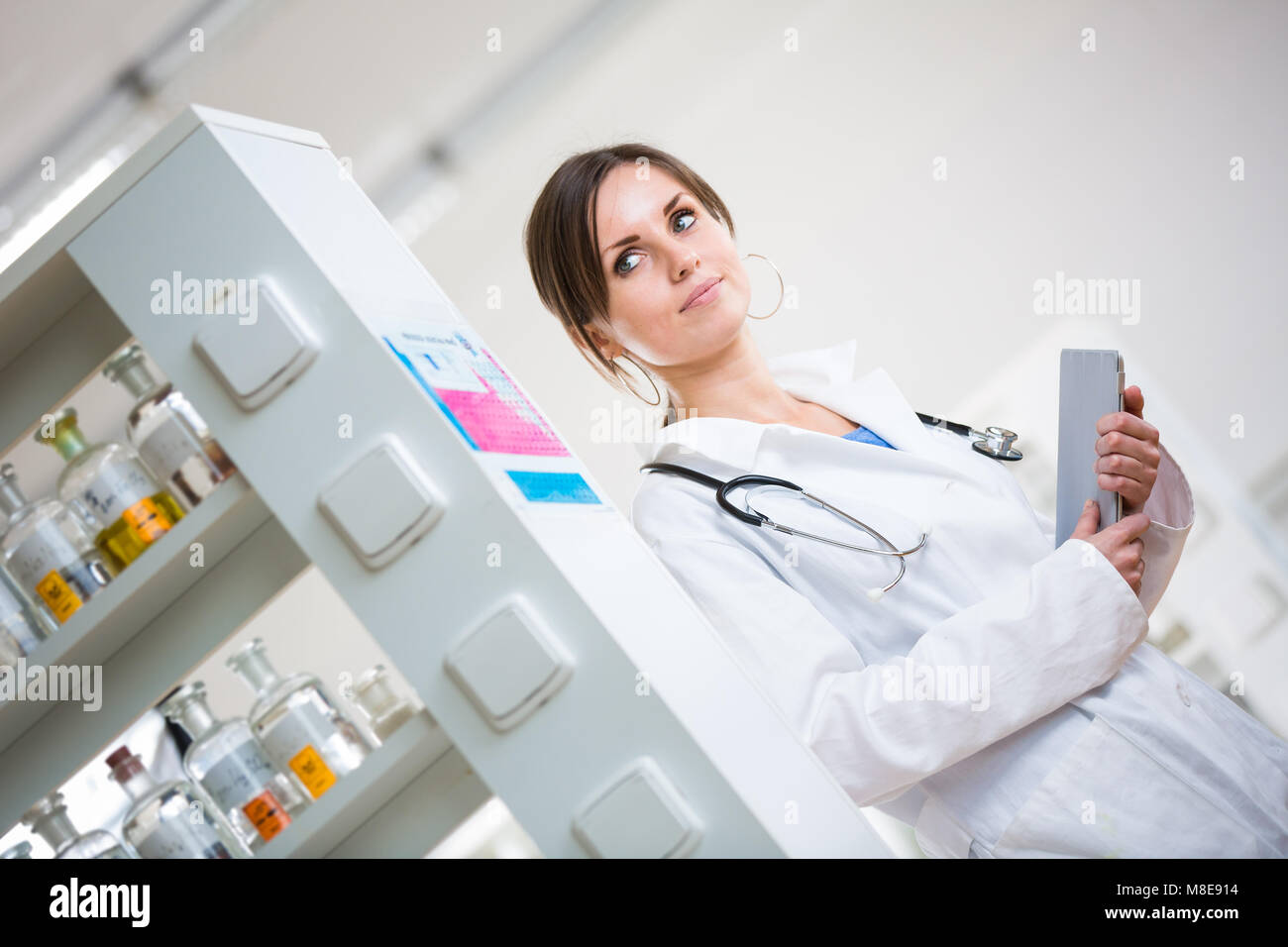 Pretty, female doctor in a hospital lab (image with copy space; color ...