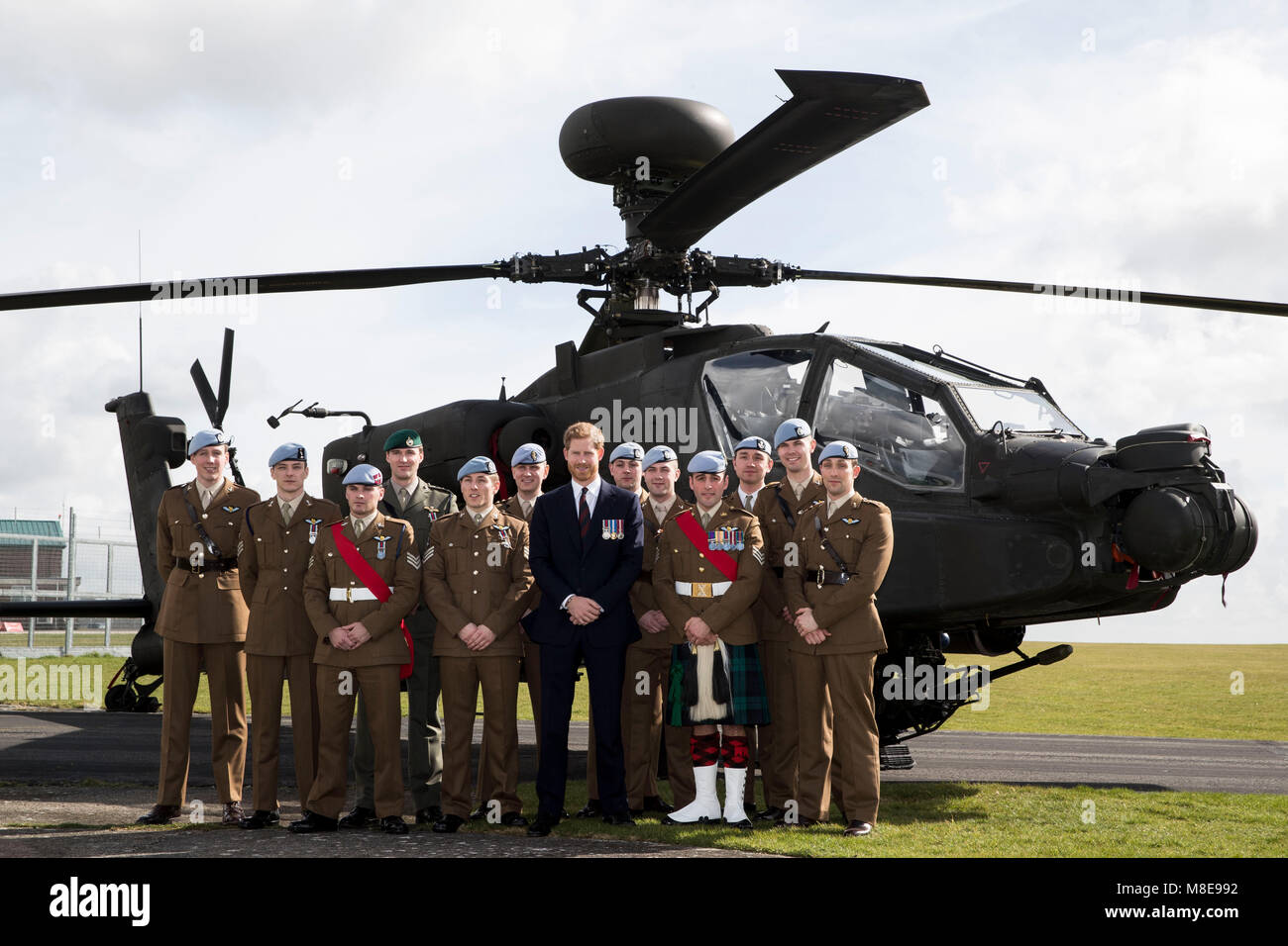 Prince Harry (centre right) poses for a photograph in front of an ...