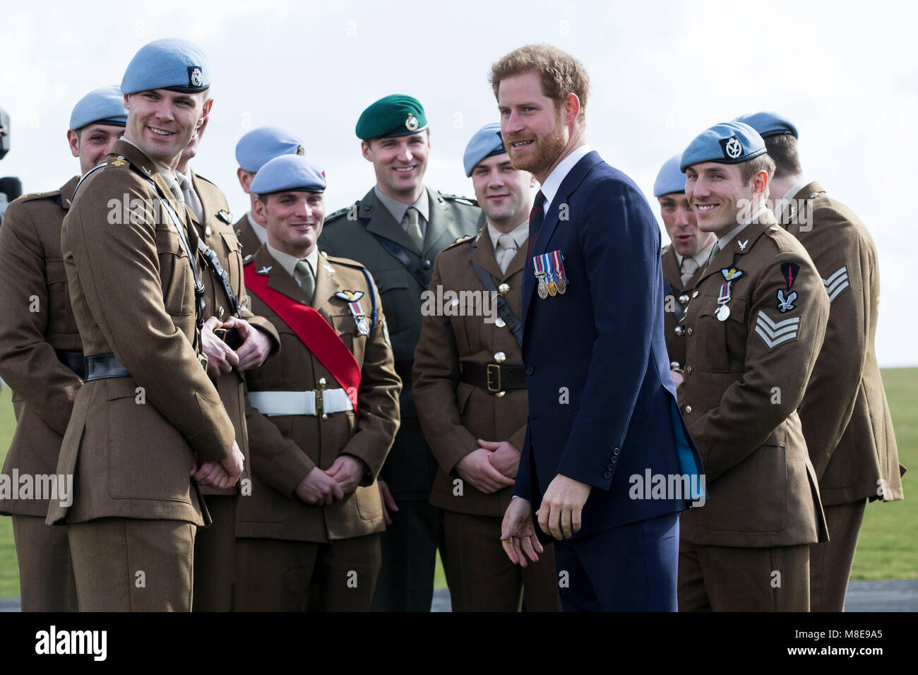 Prince Harry (centre right) poses for a photograph in front of an ...