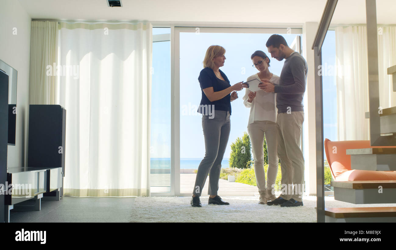 Professional Real Estate Agent Shows Stylish Modern House to a ...