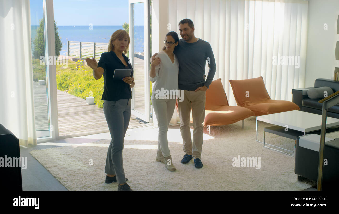 Professional Real Estate Agent Shows Stylish Modern House to a ...