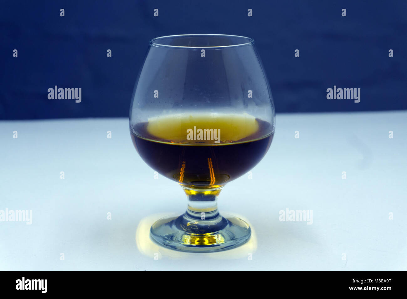 glass of brandy on a dark background Stock Photo - Alamy
