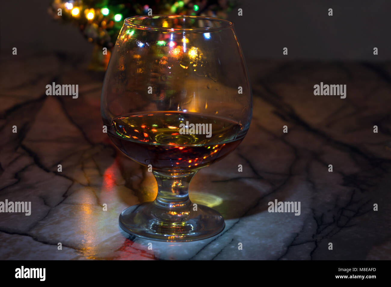 a glass of whiskey and Christmas tree Stock Photo - Alamy