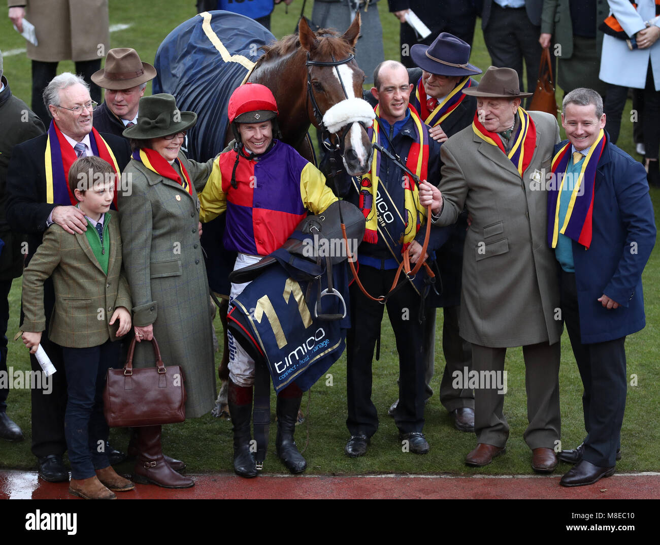 Jockey Richard Johnson (centre) celebrates winning the Timico ...