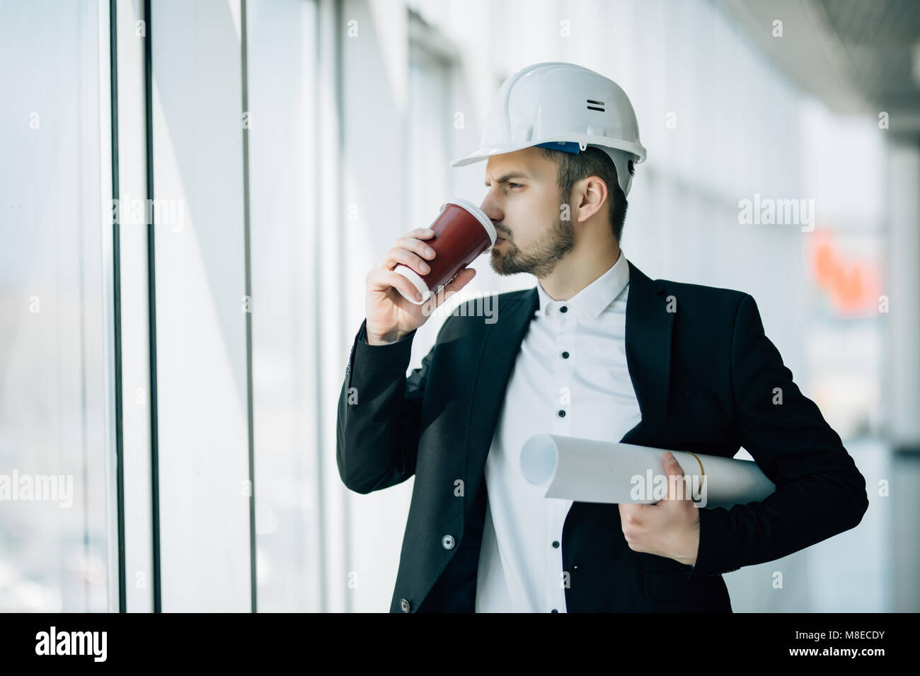 Architect man holding blueprints, engineer inspection in workplace for ...