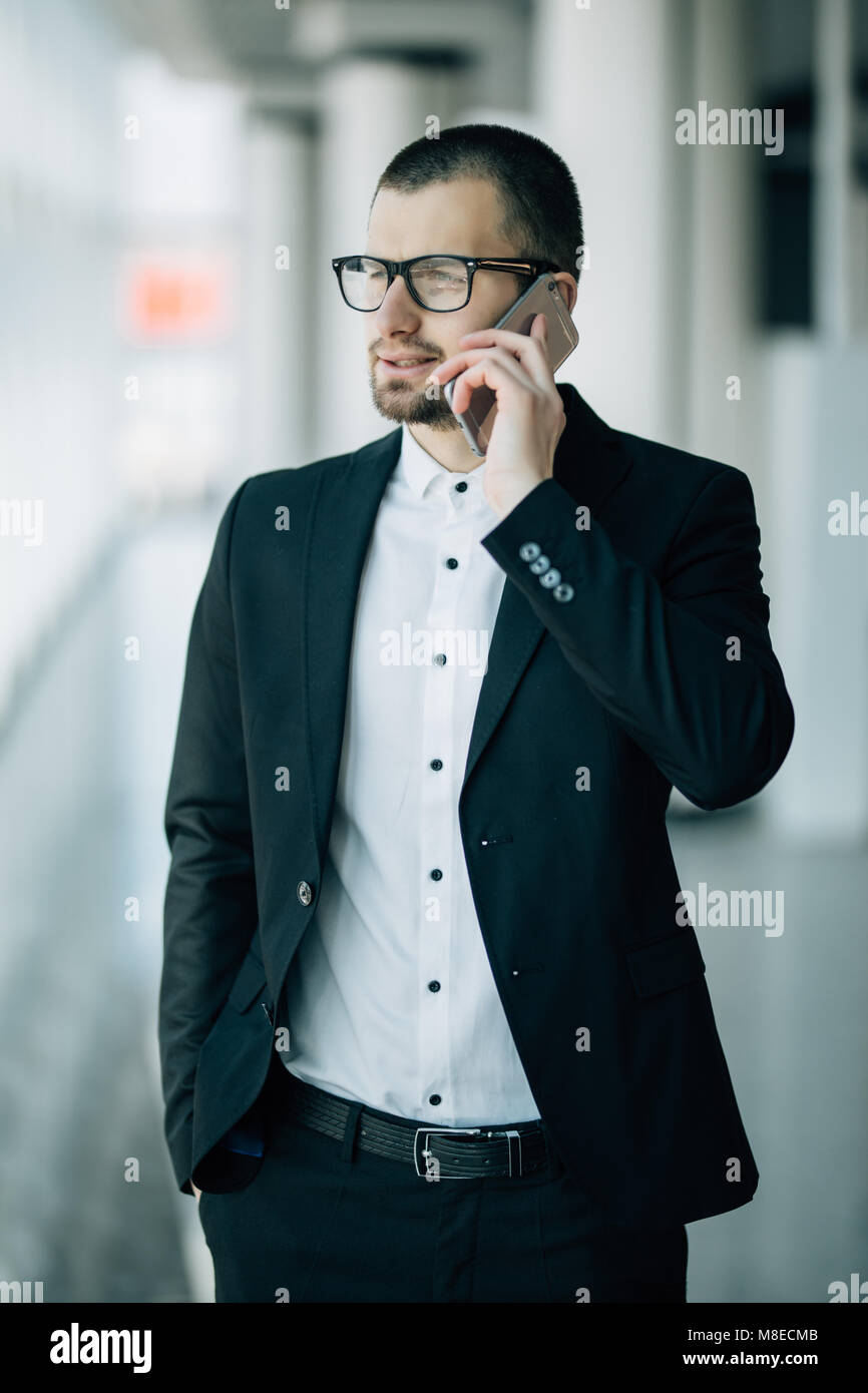 Handsome business CEO with designer stubble, talking confidently on his ...