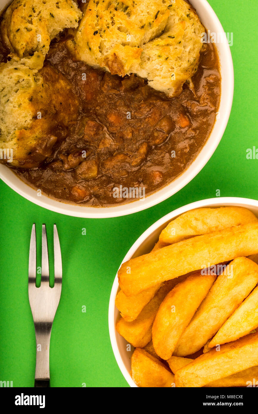 Traditional British Beef Casserole With Dumplings Against A Green ...