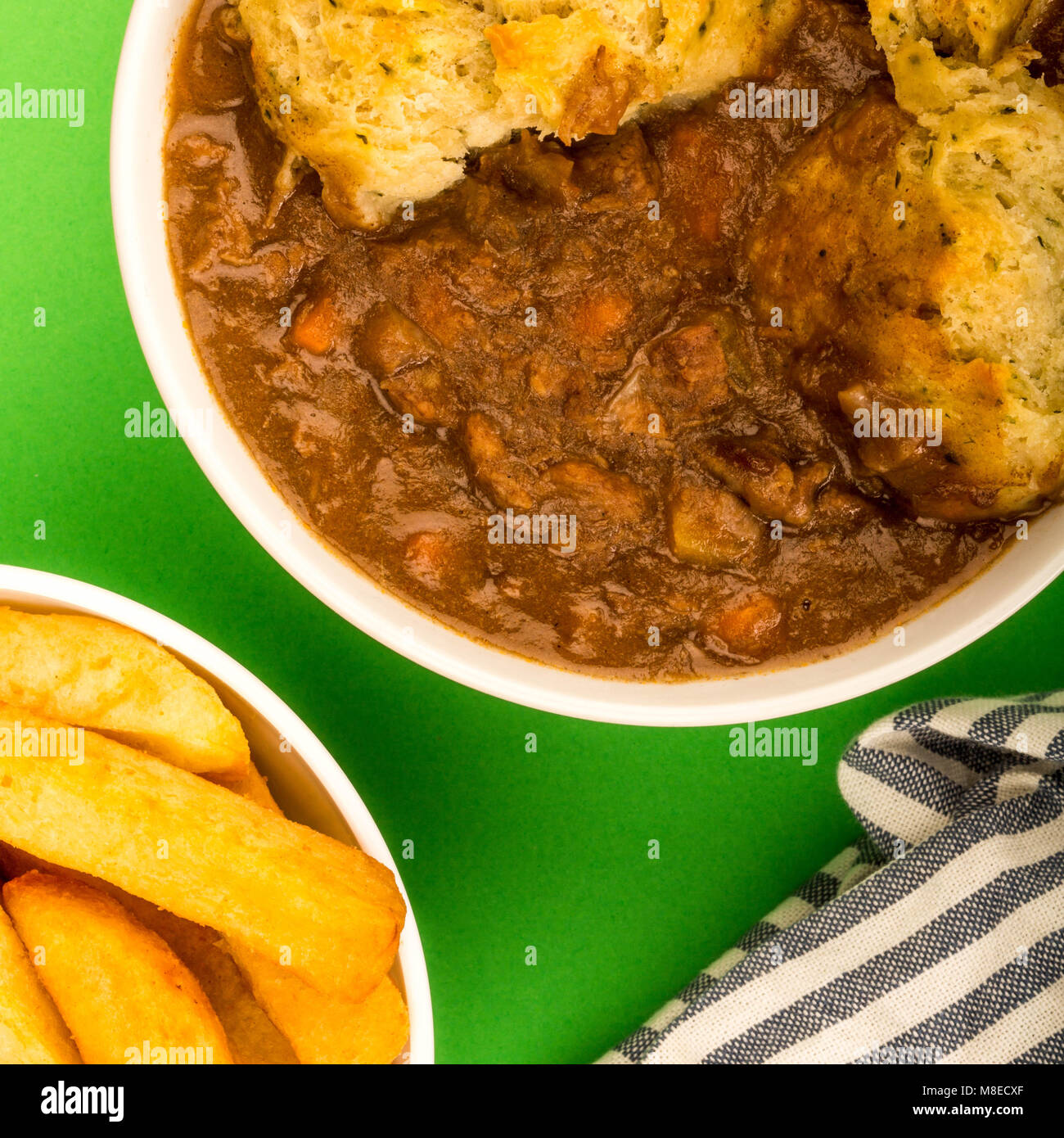 Traditional British Beef Casserole With Dumplings Against A Green ...