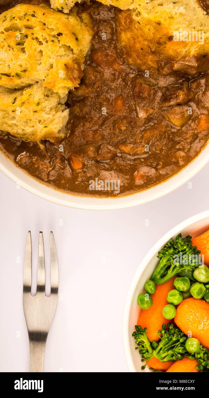 Traditional British Beef Casserole With Dumplings Against A Pale Blue ...