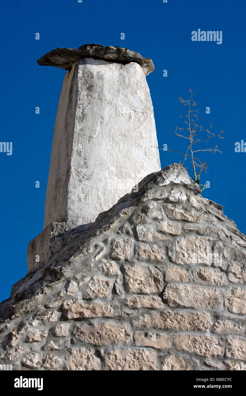 White painted chimney on old mediterranean stone house in Croatia on ...