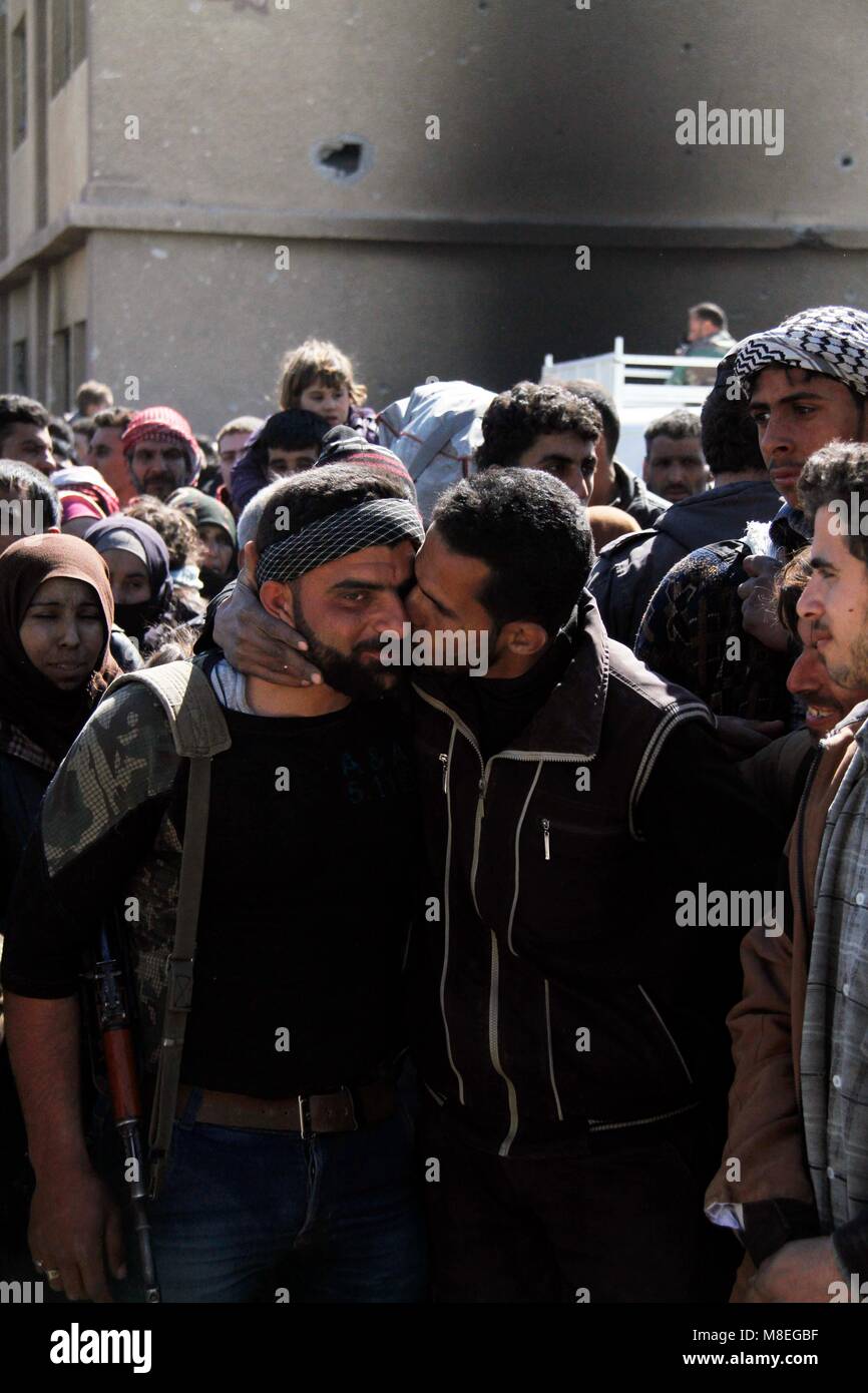 Damascus, Syria. 16th Mar, 2018. A Syrian man kisses his soldier ...