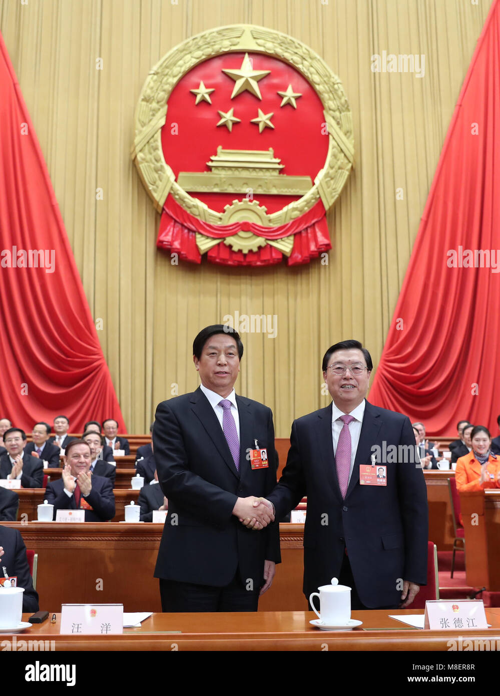 Beijing, China. 17th Mar, 2018. Li Zhanshu (L, front) shakes hands with ...