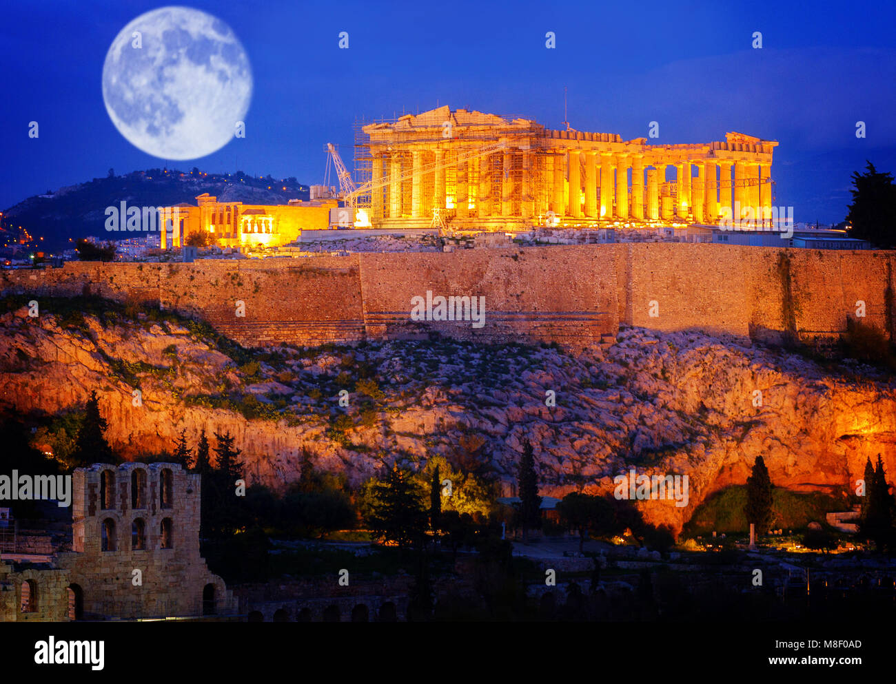 Famous skyline of Athens with Acropolis hill and Pathenon illuminated at night with moon, Athens ...