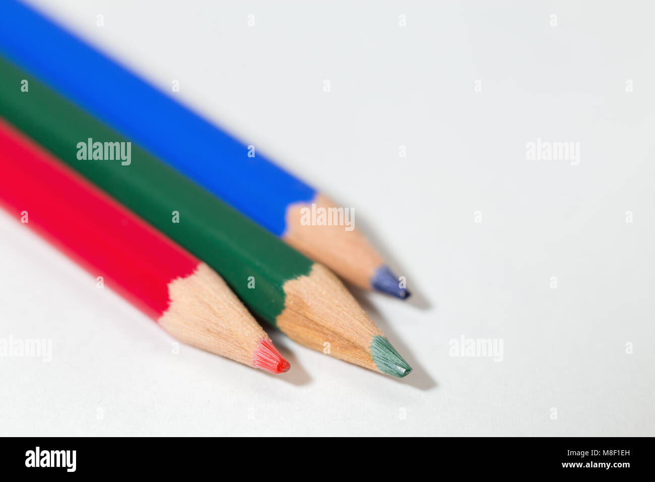 three colored pencils in the colors red green blue Stock Photo - Alamy
