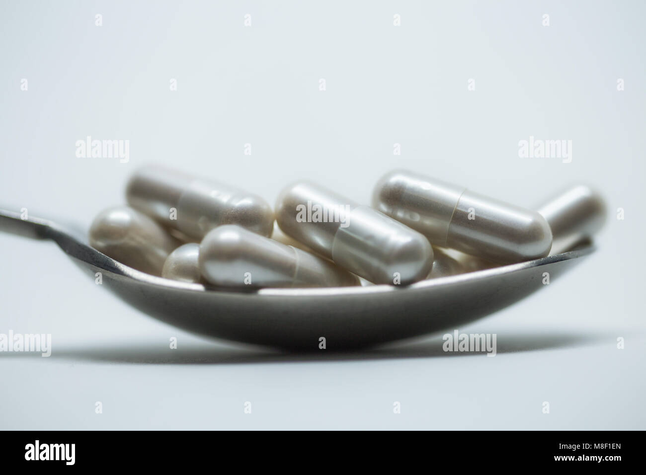 Medication in pill form on a spoon Stock Photo - Alamy