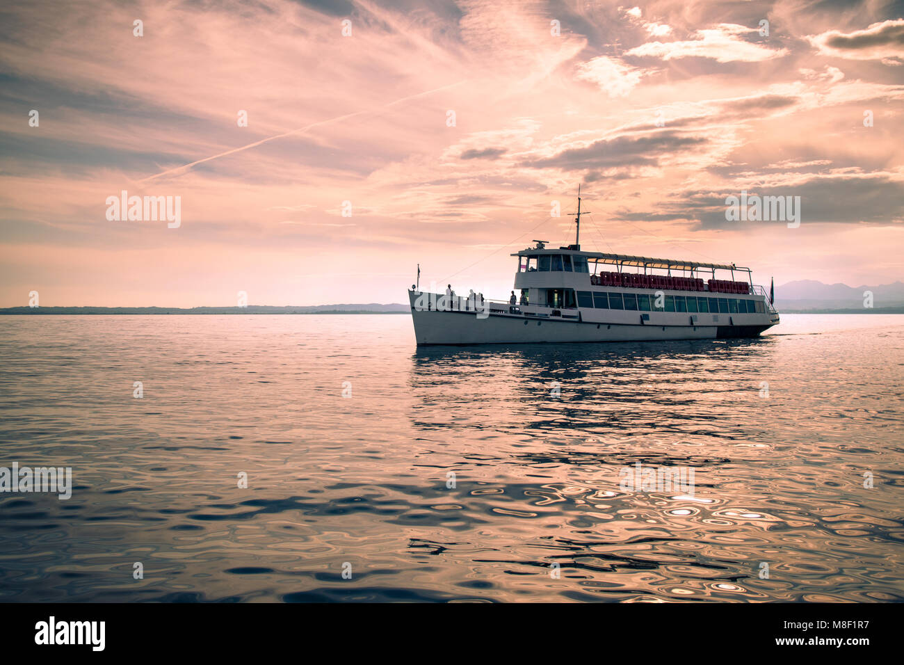 White ferry on Lake Garda at sunset Stock Photo - Alamy