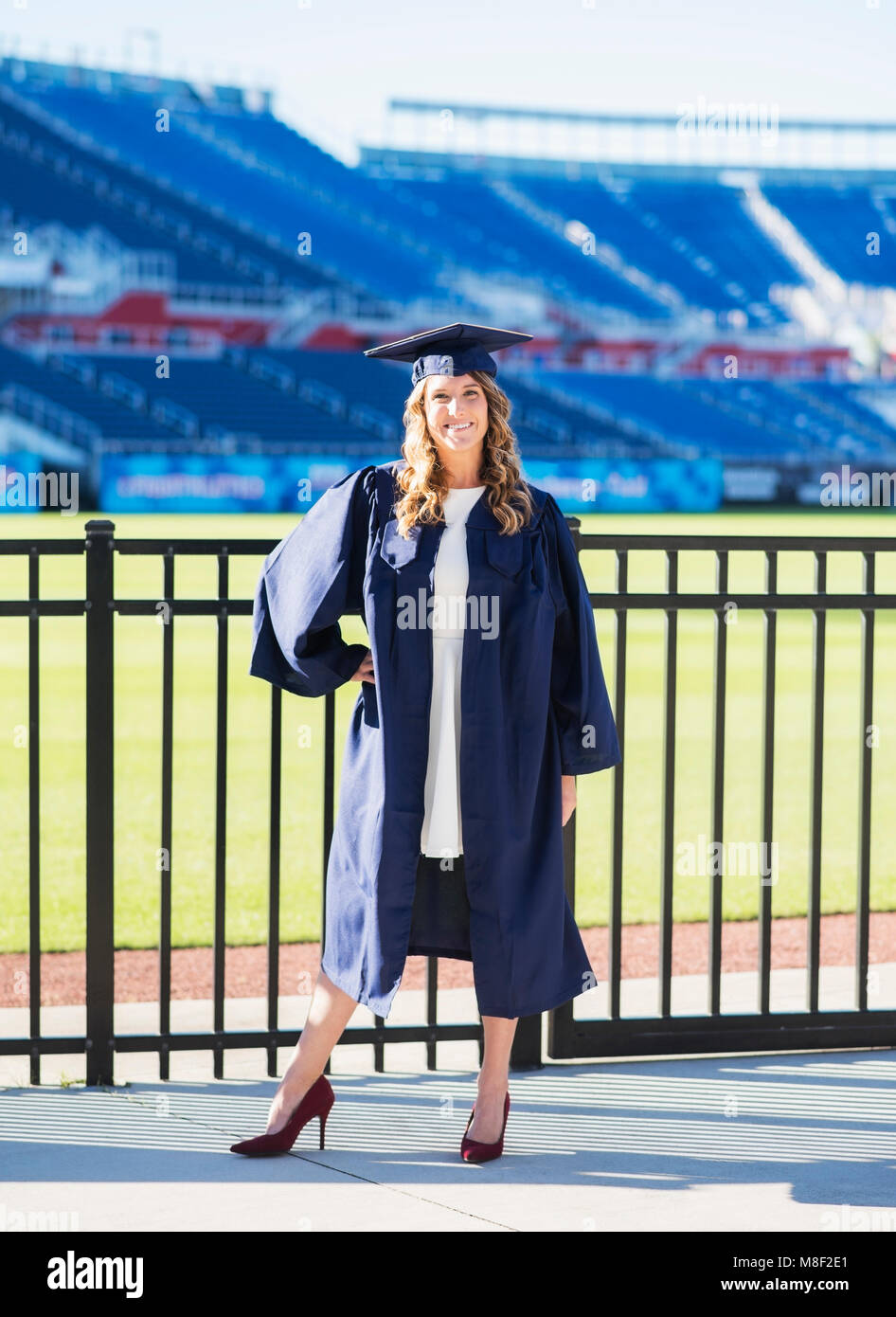 Young woman graduate standing outdoors hi-res stock photography and ...