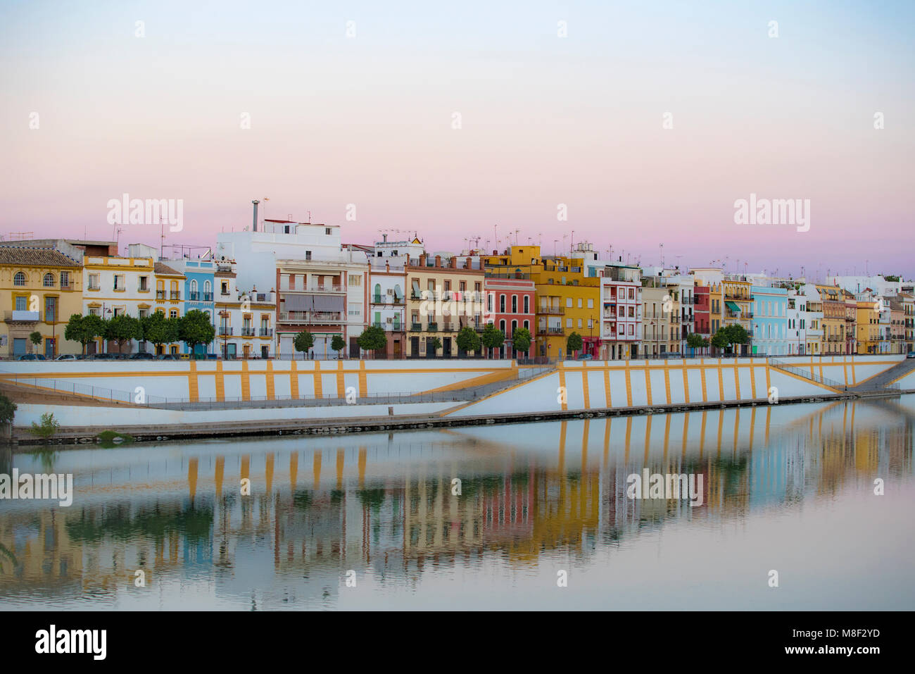 Spain, Seville, Colorful residential building reflecting in ...