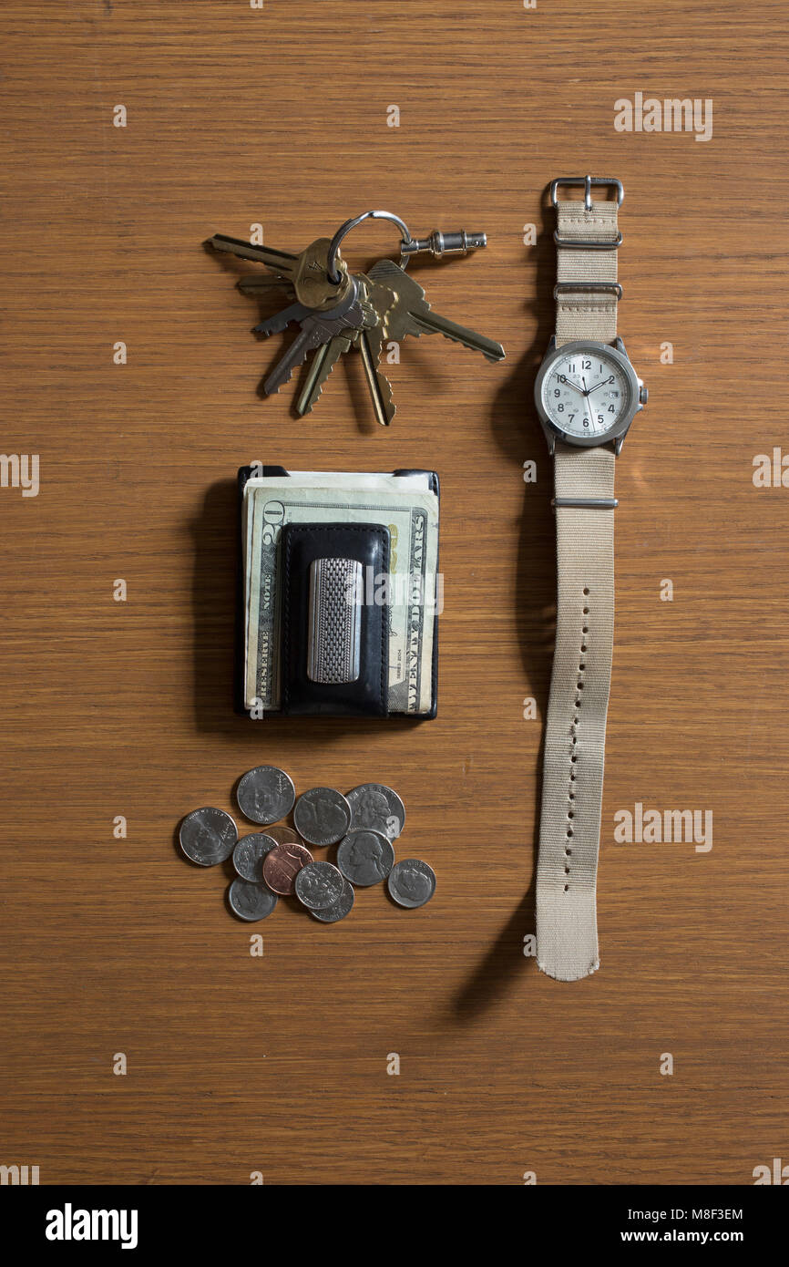 Watch, keys and money on table Stock Photo - Alamy