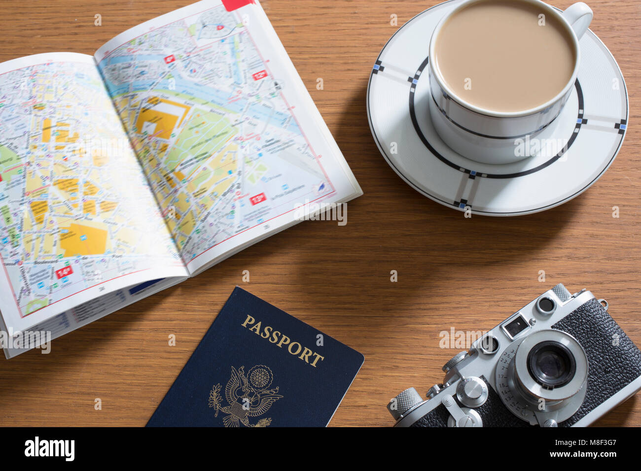Passport, coffee, old camera and open guidebook Stock Photo - Alamy
