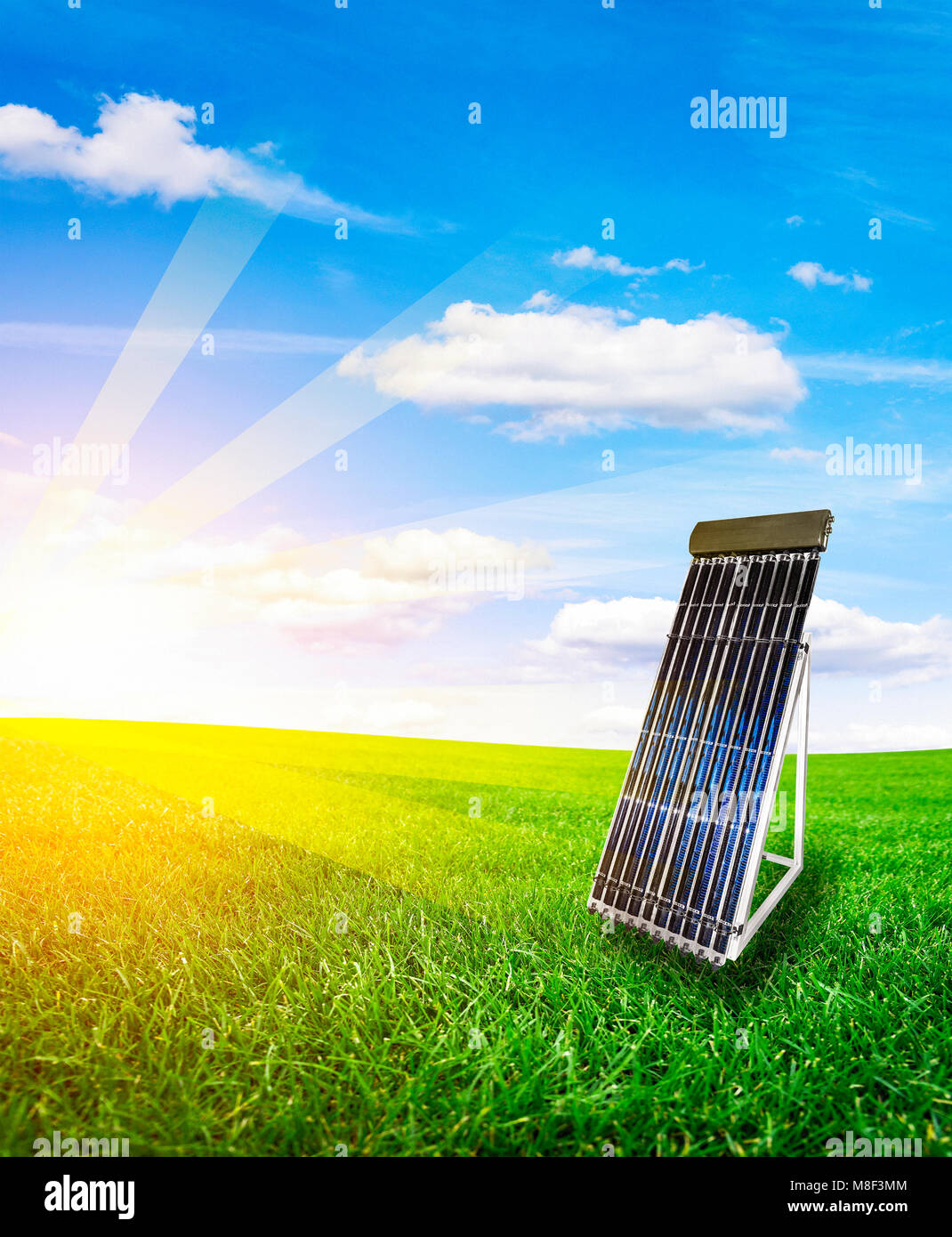 Solar panel battery on the field with green grass blue sky and rays of ...