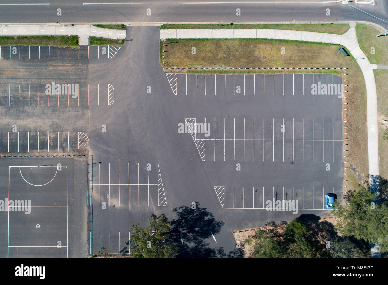 Parking lot next to playing field Stock Photo - Alamy